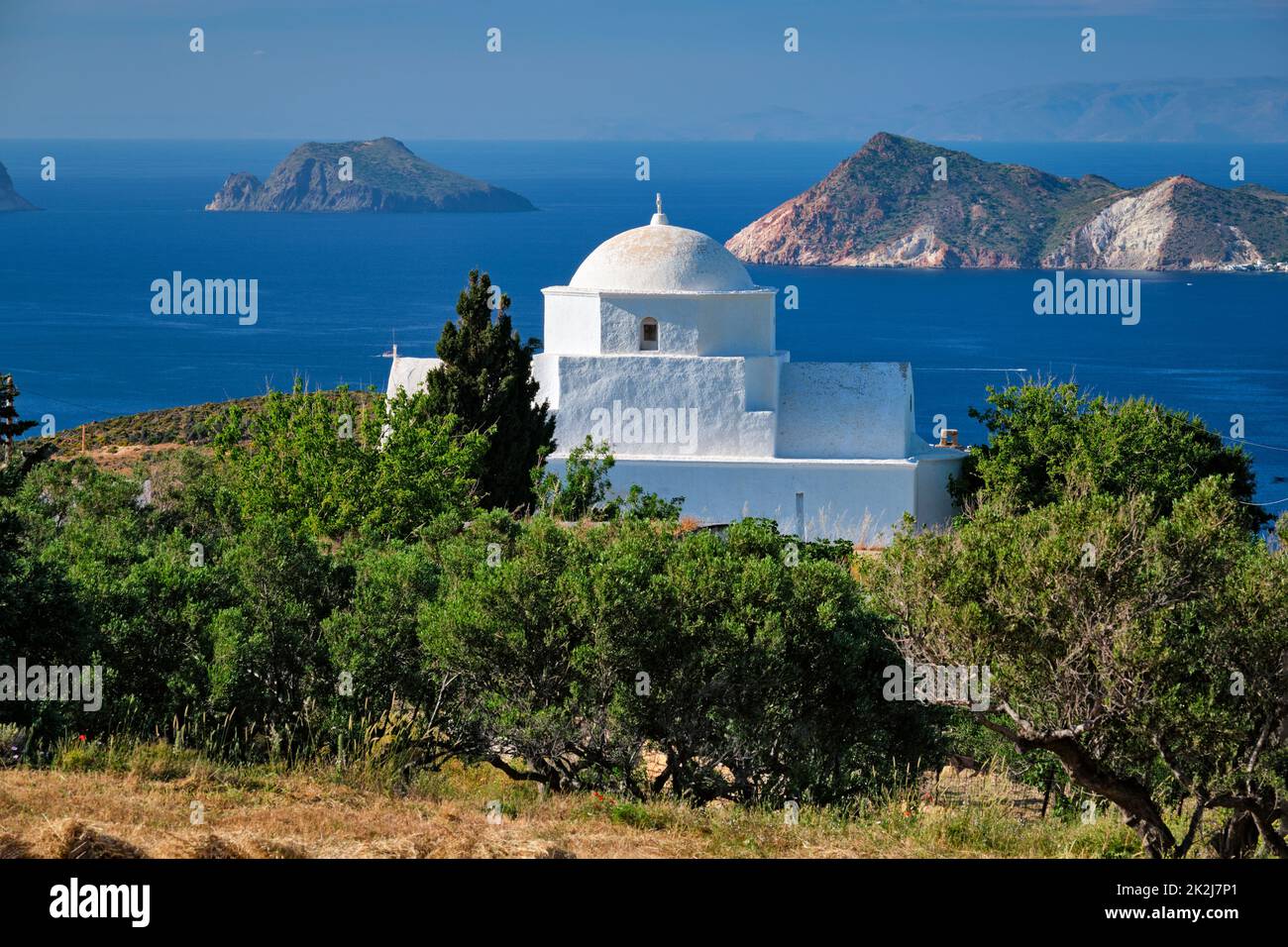 View of Milos island and Greek Orthodox traditional whitewashed church ...
