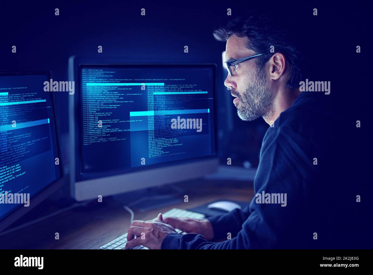 Immersed in the metadata. Shot of a focussed computer hacker using a ...
