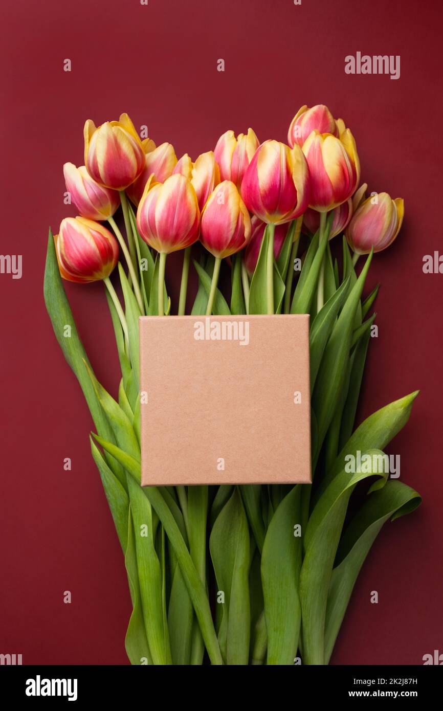 Gift craft box mockup Empty craft box on top of beautiful tulip bouquet ...