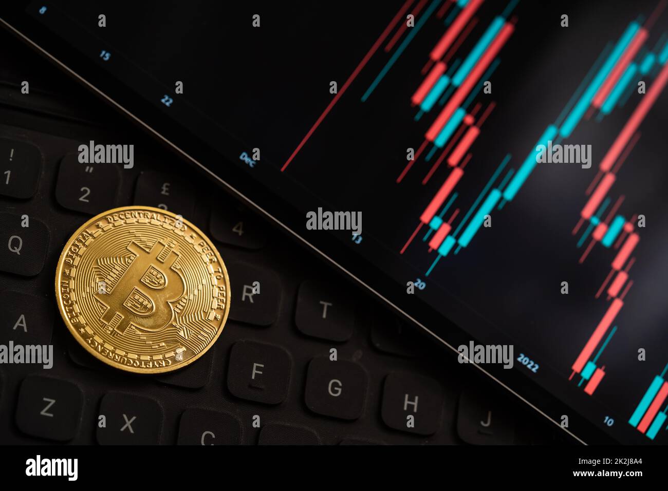 Bitcoin cryptocurrency with candle stick graph chart, laptop keyboard ...