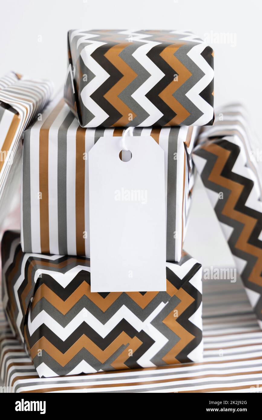 Wrapped present with blank vertical gift tag close up, label Mockup ...