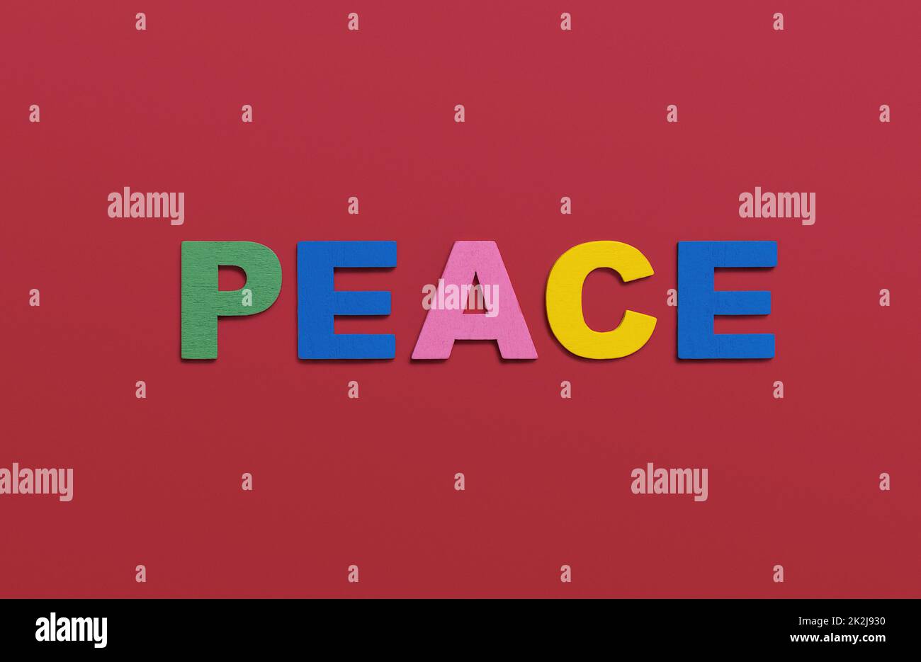 Peace, word written in colorful wooden alphabet letters on red ...