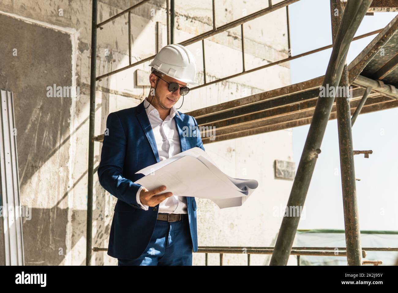 Man architect wearing formal suit and hard hat during building ...