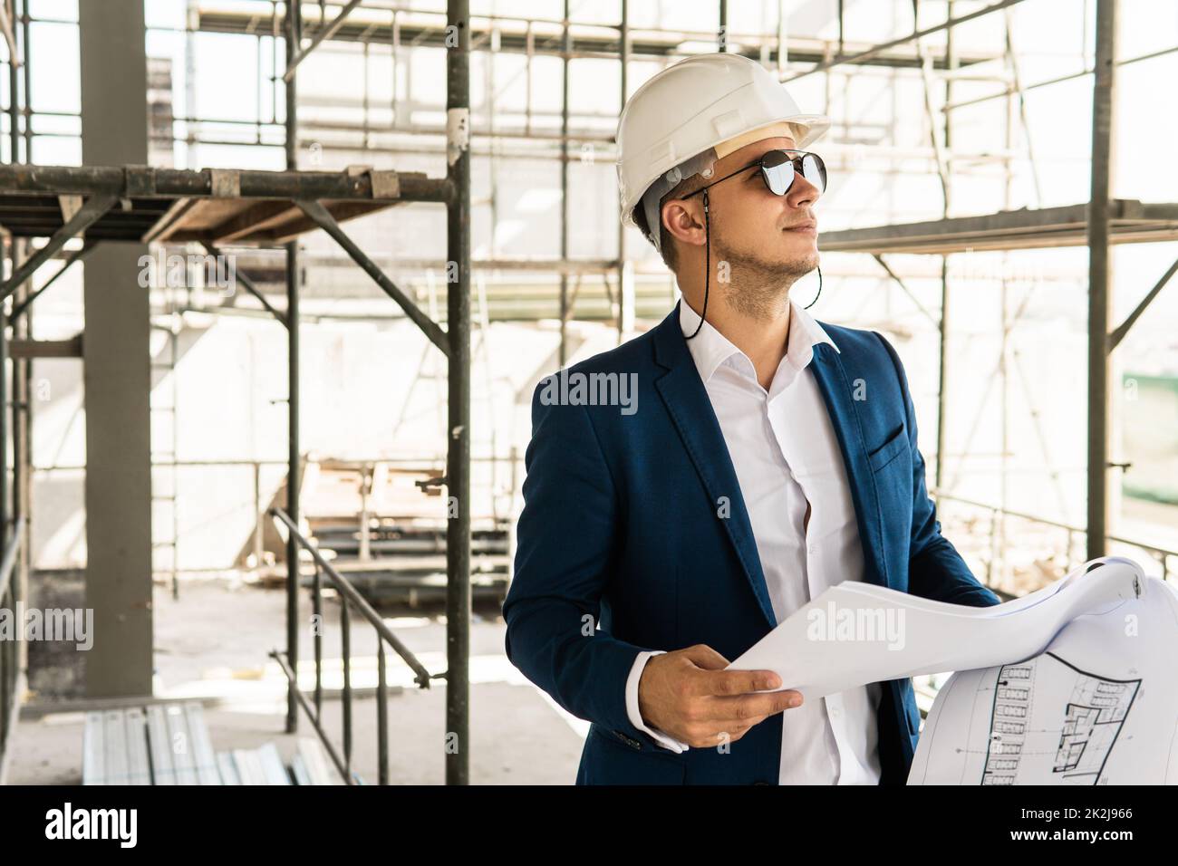 Man architect wearing formal suit and hard hat during building ...