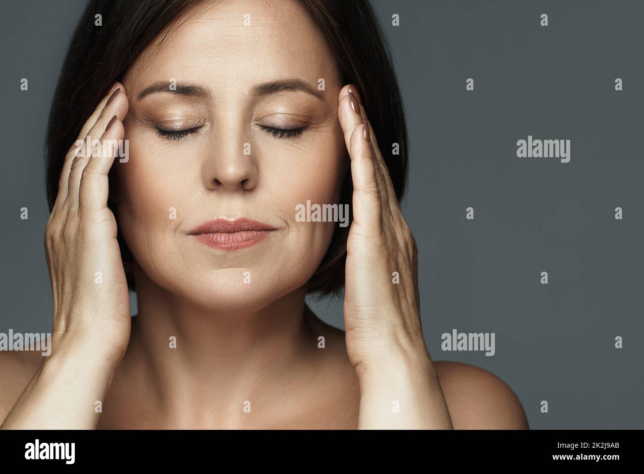 Beautiful middle aged woman with closed eyes Stock Photo - Alamy