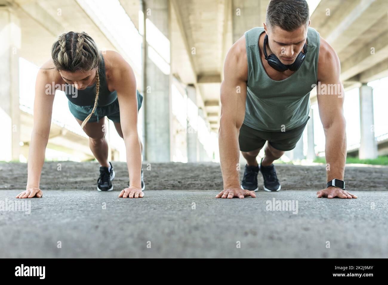 Athletic couple and fitness training outdoors. Man and woman doing push ...