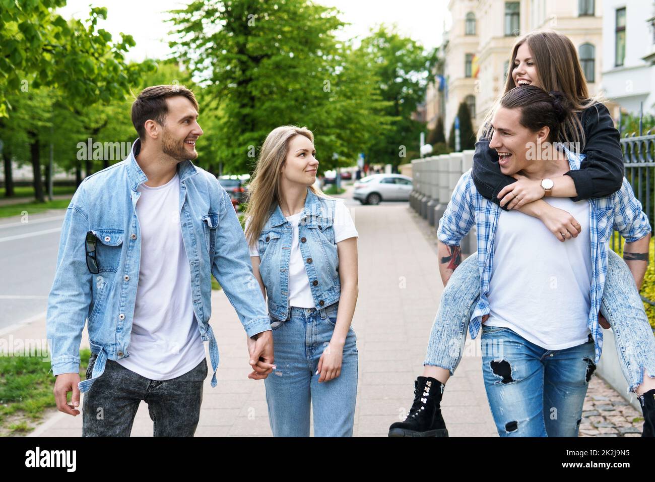 Group of best friends are having fun while walking by city street Stock ...