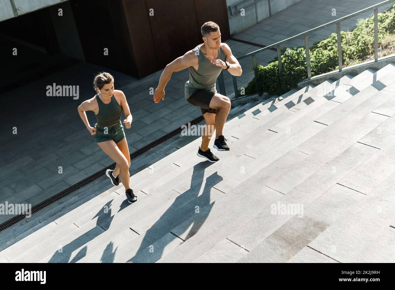 Sportive couple during workout stair running outdoors Stock Photo - Alamy