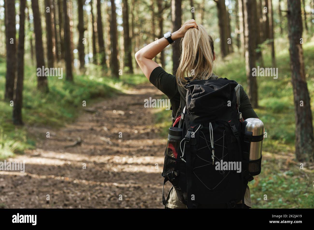 Female hiker with big backpack in green forest Stock Photo - Alamy