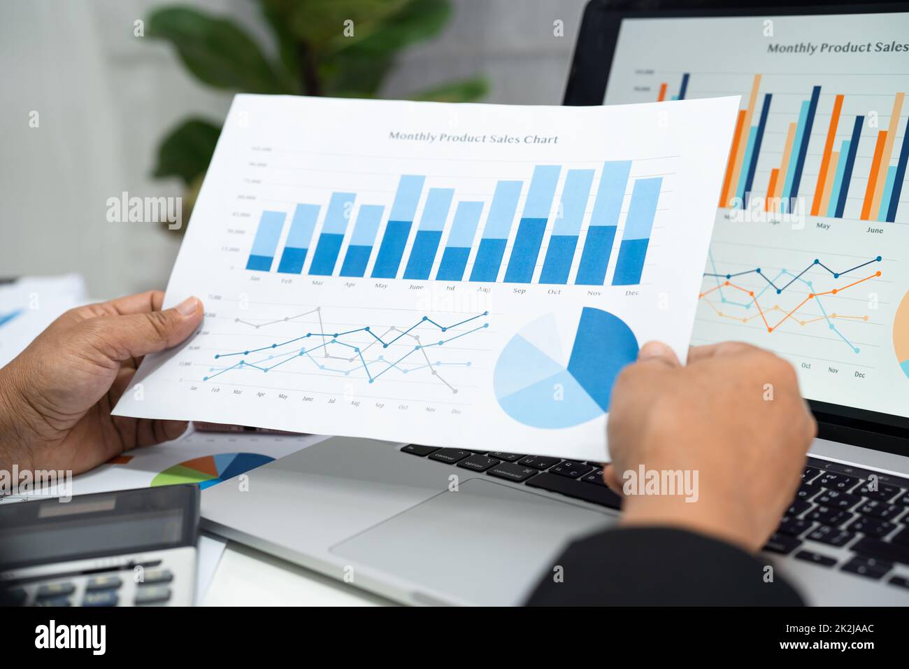 Asian accountant working and analyzing financial reports project ...