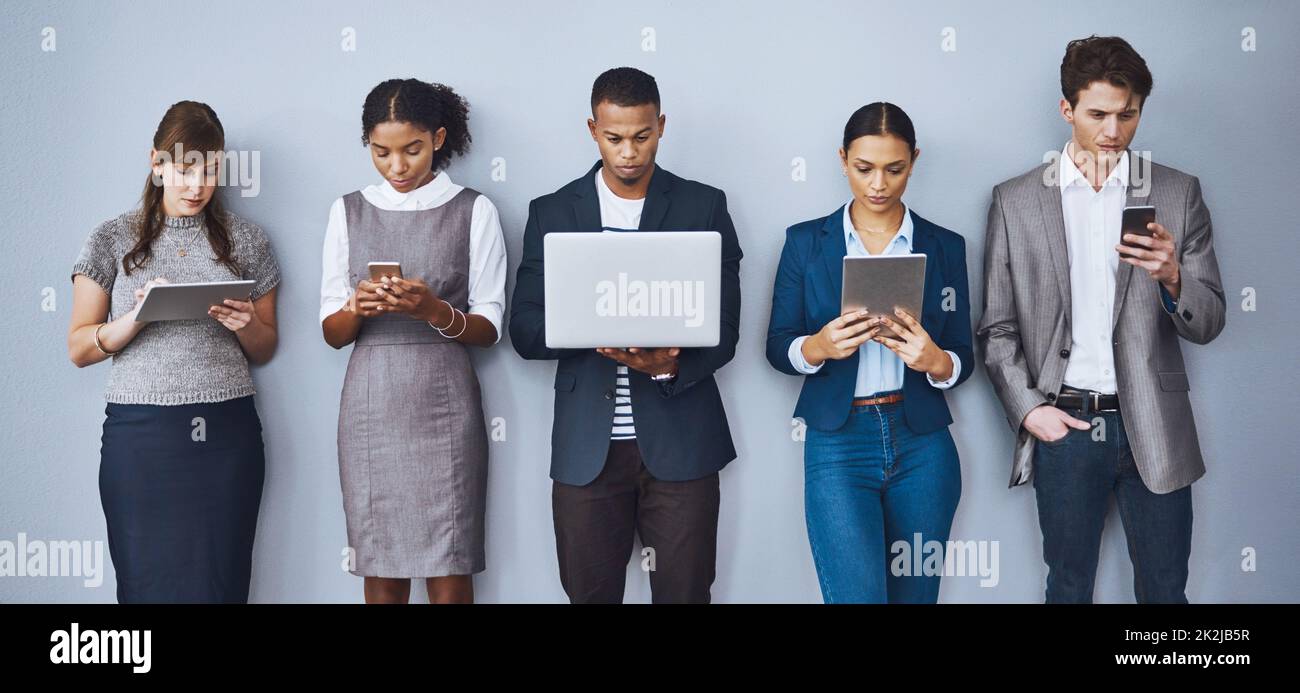 Standing in line. Cropped shot of a group of young businesspeople ...