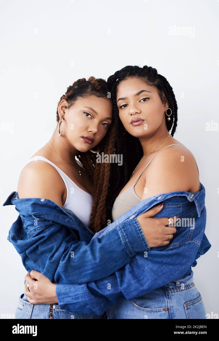 They complete each others look. Studio shot of two beautiful young ... They complete each others look. Studio shot of two beautiful young ...