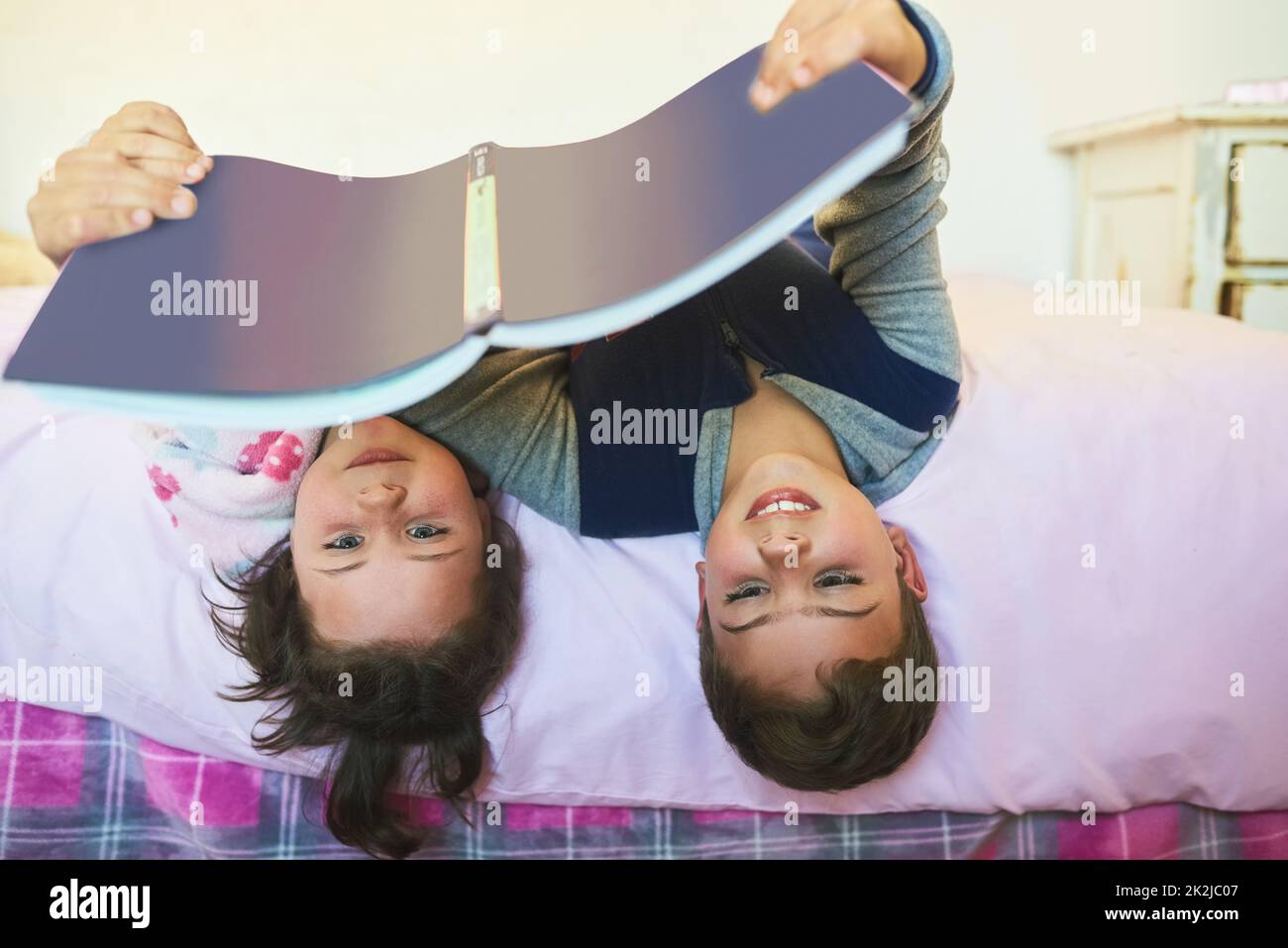 Child holding book upside down hi-res stock photography and images - Alamy