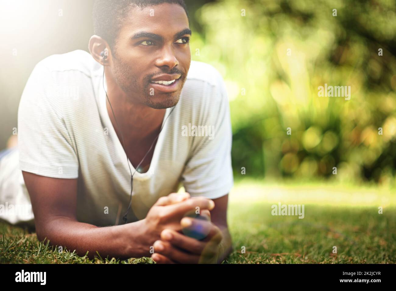 The song that reminds you of that special person. Shot of a young man ...