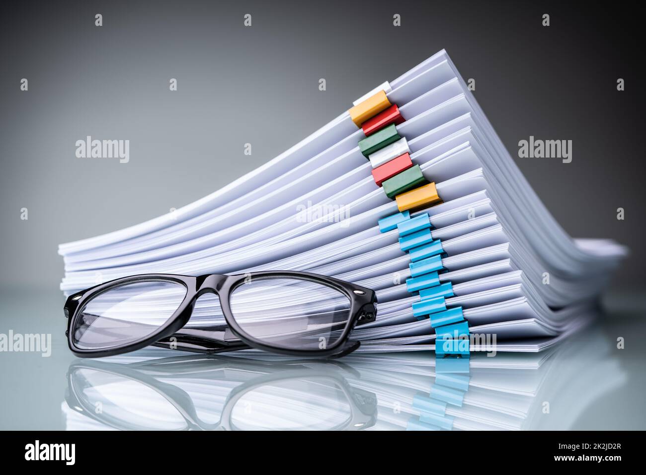 Stacked Documents With Colorful Paperclips Stock Photo - Alamy