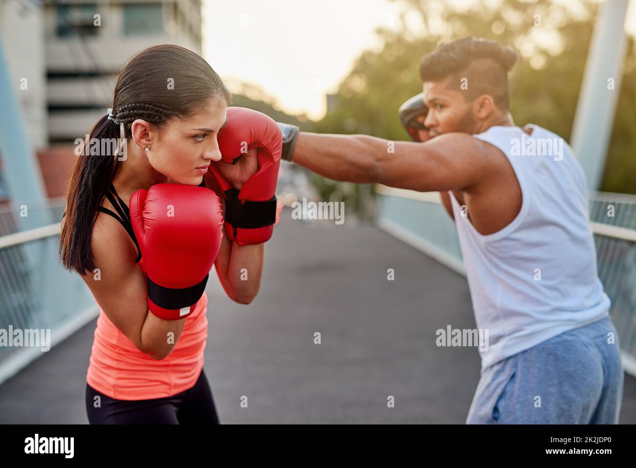 Bob and weave. Shot of a young couple going through some kickboxing ...