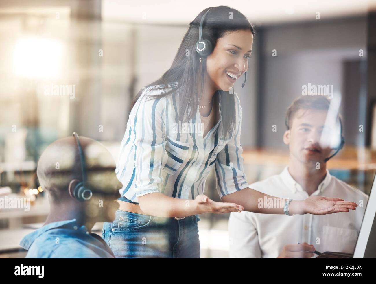 Call center, team manager training employees with computer in ...