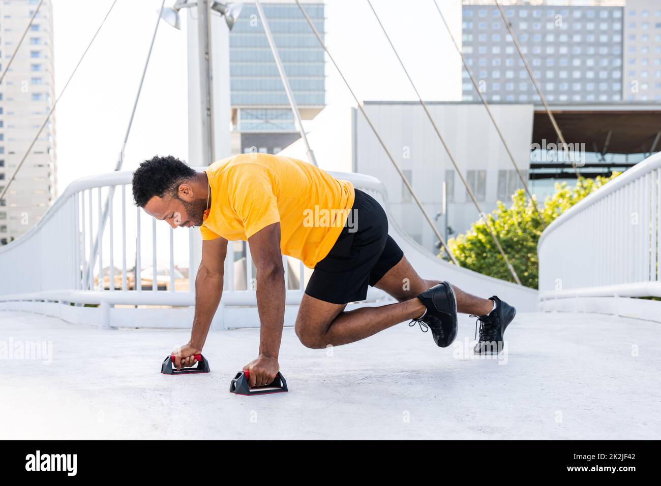 Black hispanic sportsman training outdoors in the city - African man ...