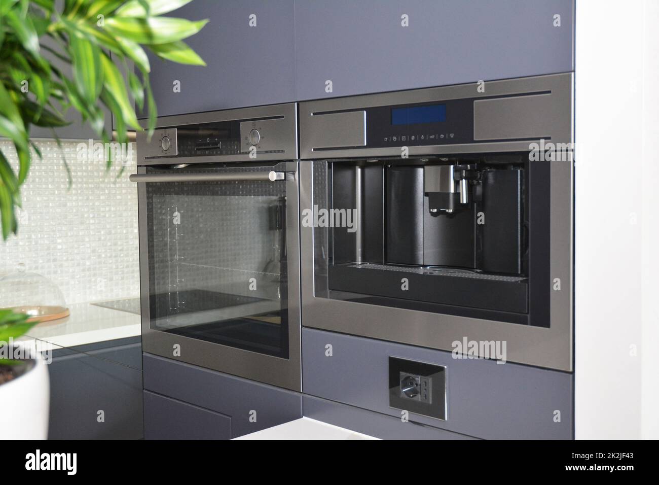 Modern kitchen with electric oven, electric stove and coffee machine ...