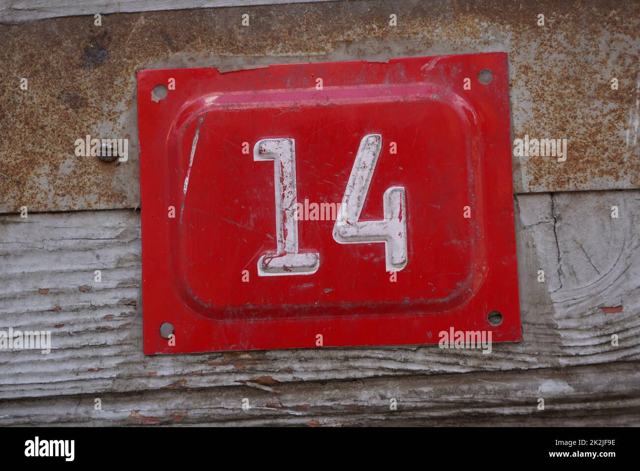 House number 14 on a rusty old metal sign on a brick wall Stock Photo ...