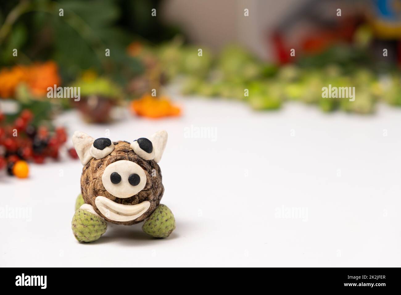 Pig figurine made of cone and plasticine, children's crafts, space for ...