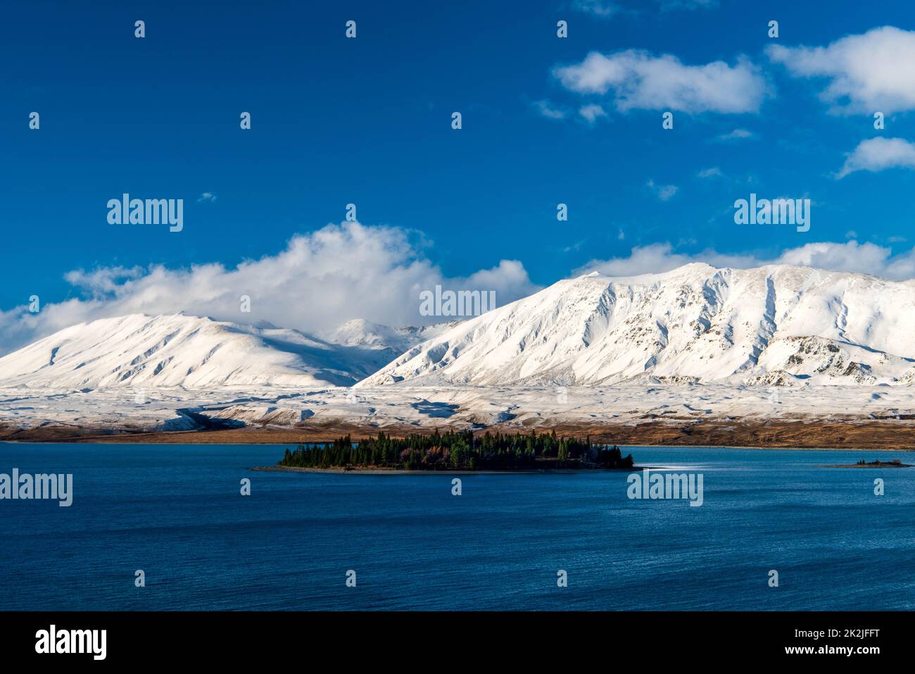 Mount Dobson mountain range is viewed from the banks of Lake Tekapo ...