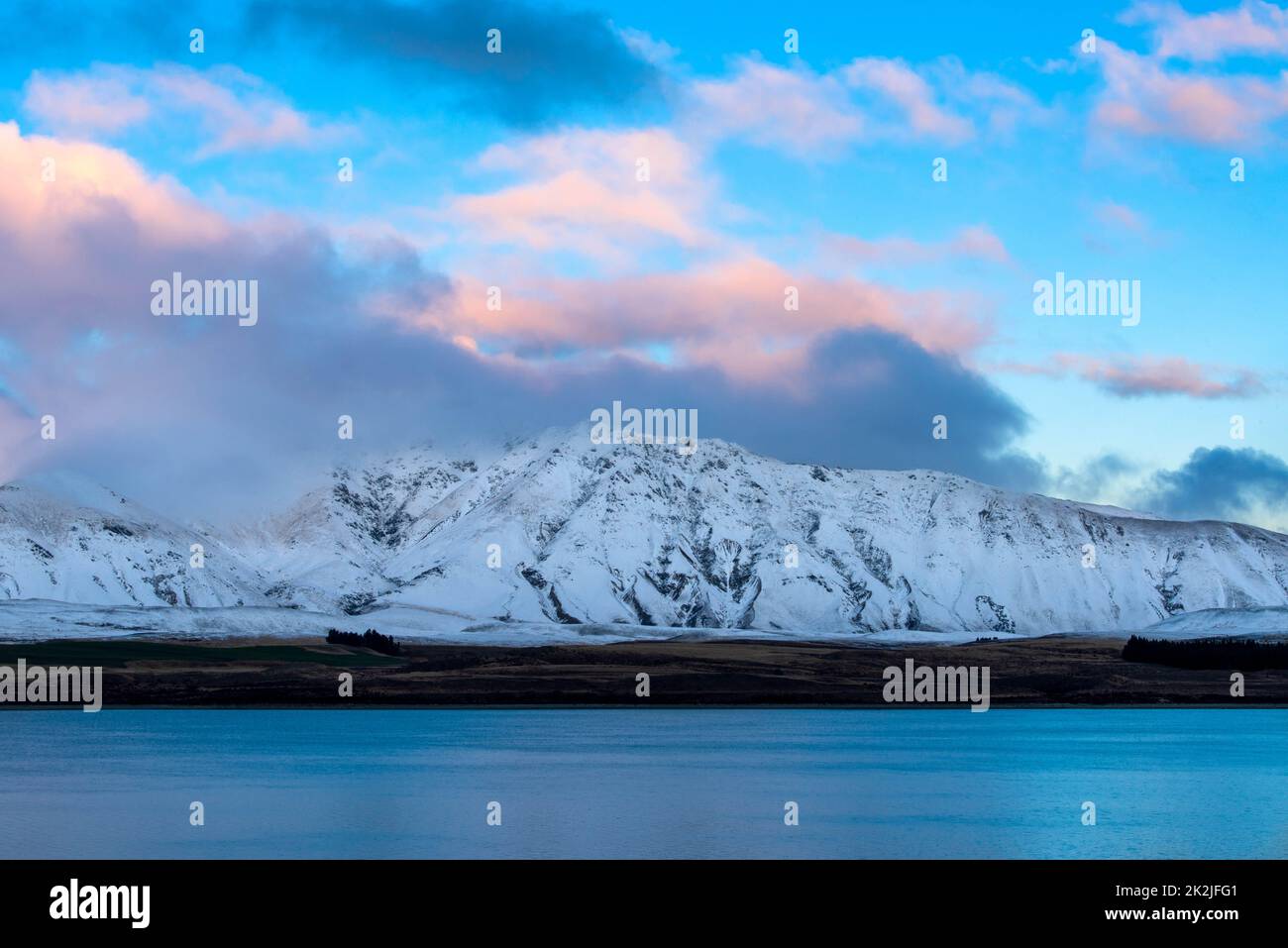 Mount Dobson mountain range is viewed from the banks of Lake Tekapo ...
