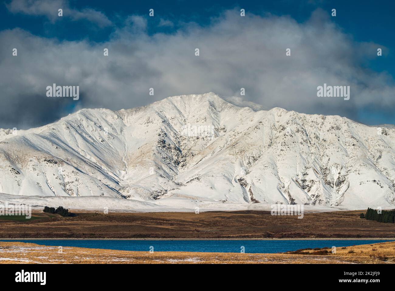 Mount Dobson mountain range is viewed from the banks of Lake Tekapo ...