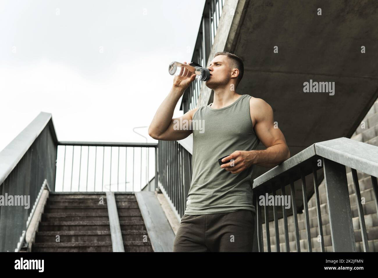 Muscular man after jogging workout on a city street Stock Photo - Alamy