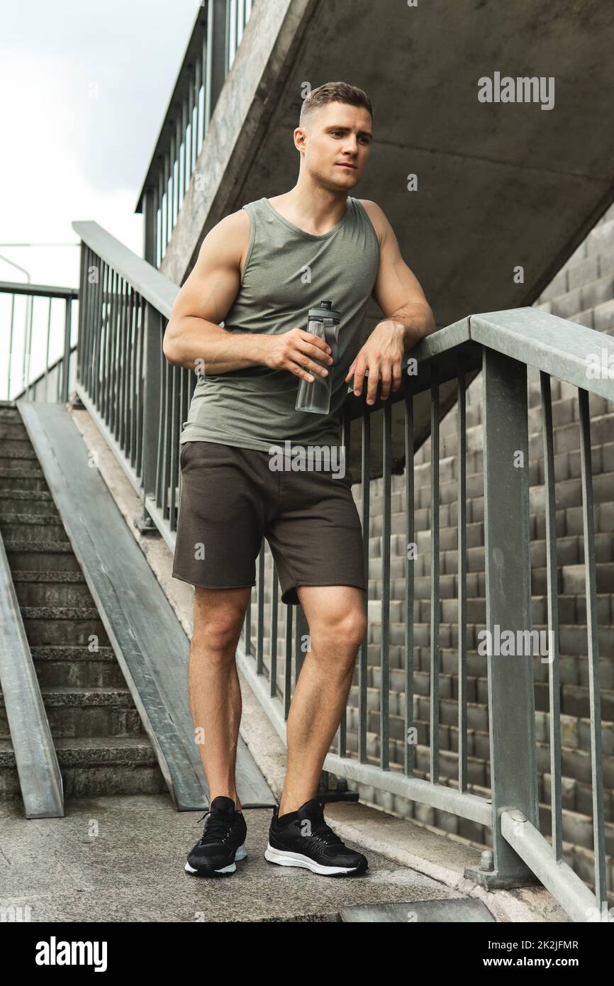 Muscular man after jogging workout on a city street Stock Photo - Alamy