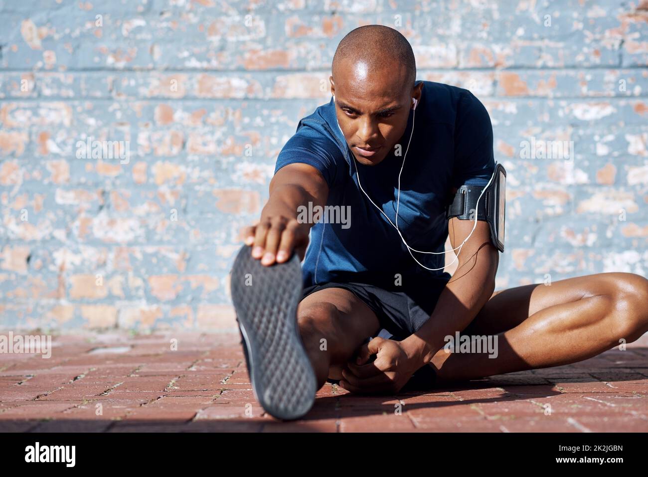 Quitting is not even a option. Shot of a sporty young man practising ...