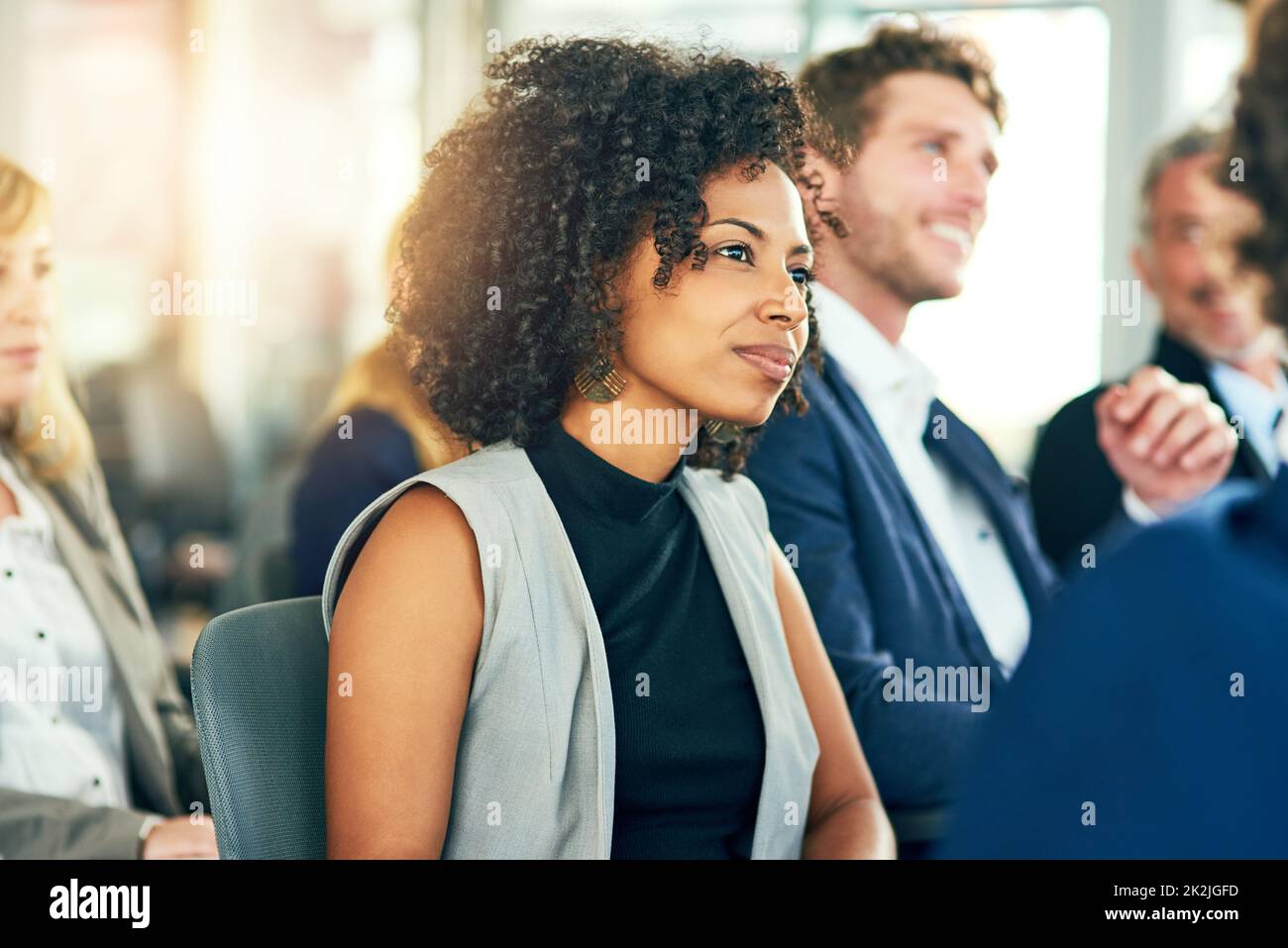 Giving the speaker her full attention. Cropped shot of an attractive ...