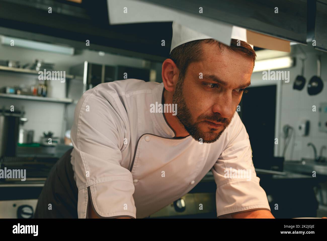 Tired chef on kitchen restaurant waiting for a new order Stock Photo ...