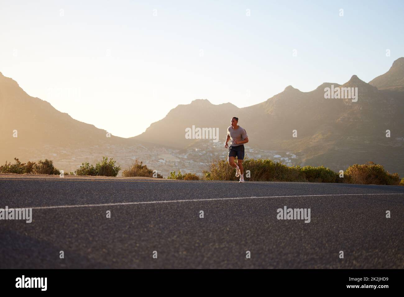 A morning jog to clear the head. Shot of a young man running alone ...