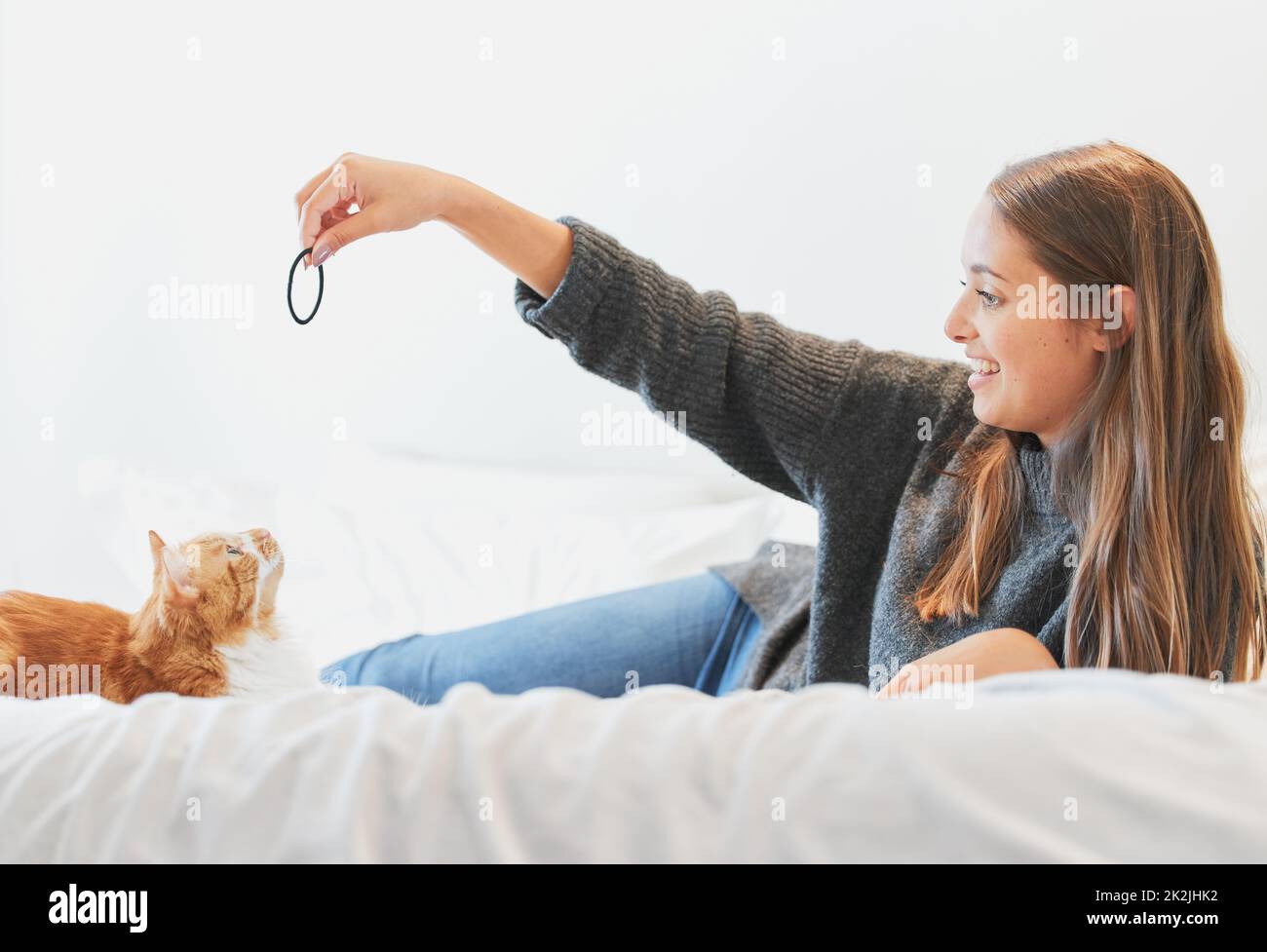 Woman playing cat toy hi-res stock photography and images - Alamy