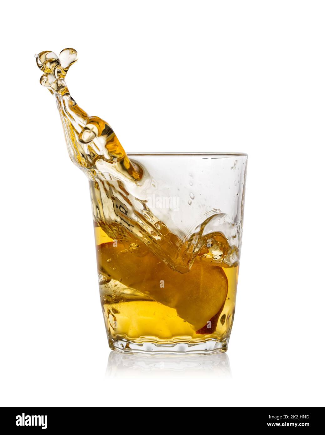 Glass of apple juice with splash from red apple slice Stock Photo - Alamy