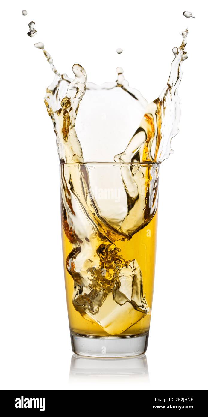 Glass of apple juice with splash from an ice cube Stock Photo - Alamy