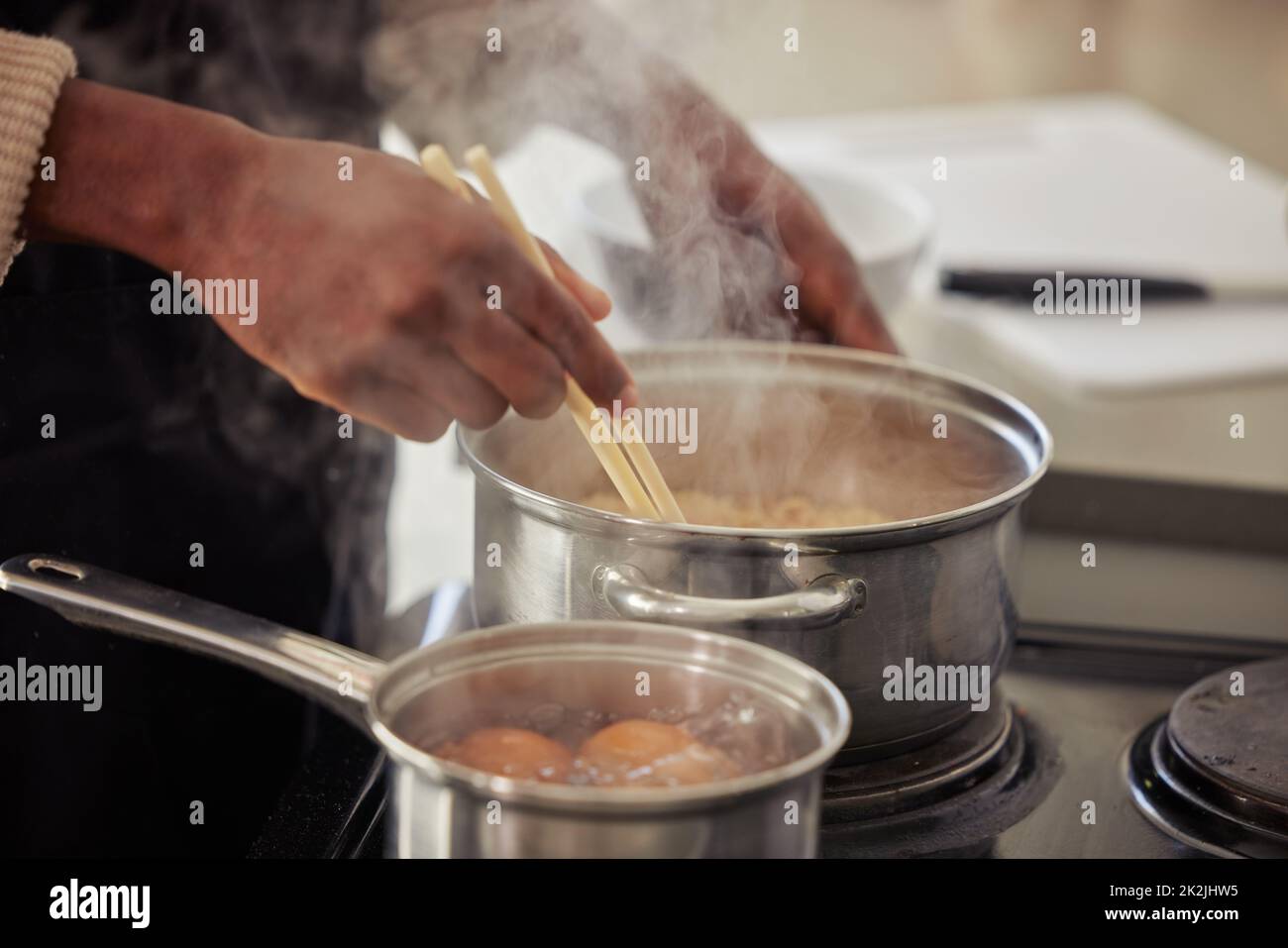 Cooking up a storm. Cropped shot of an unrecognizable man cooking on ...