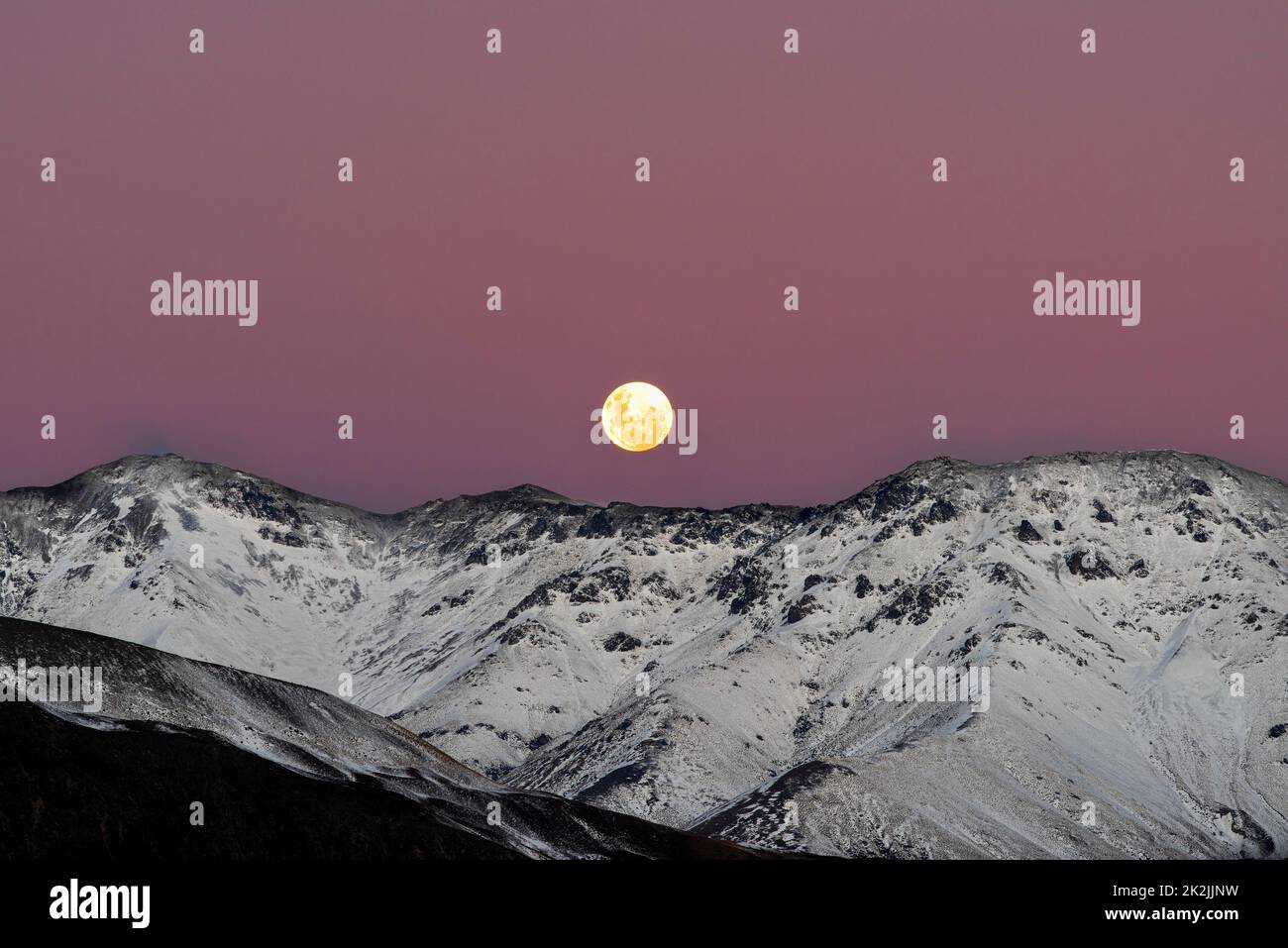 a super moon rises over Mount Dobson on the shores of Lake Tekapo on ...