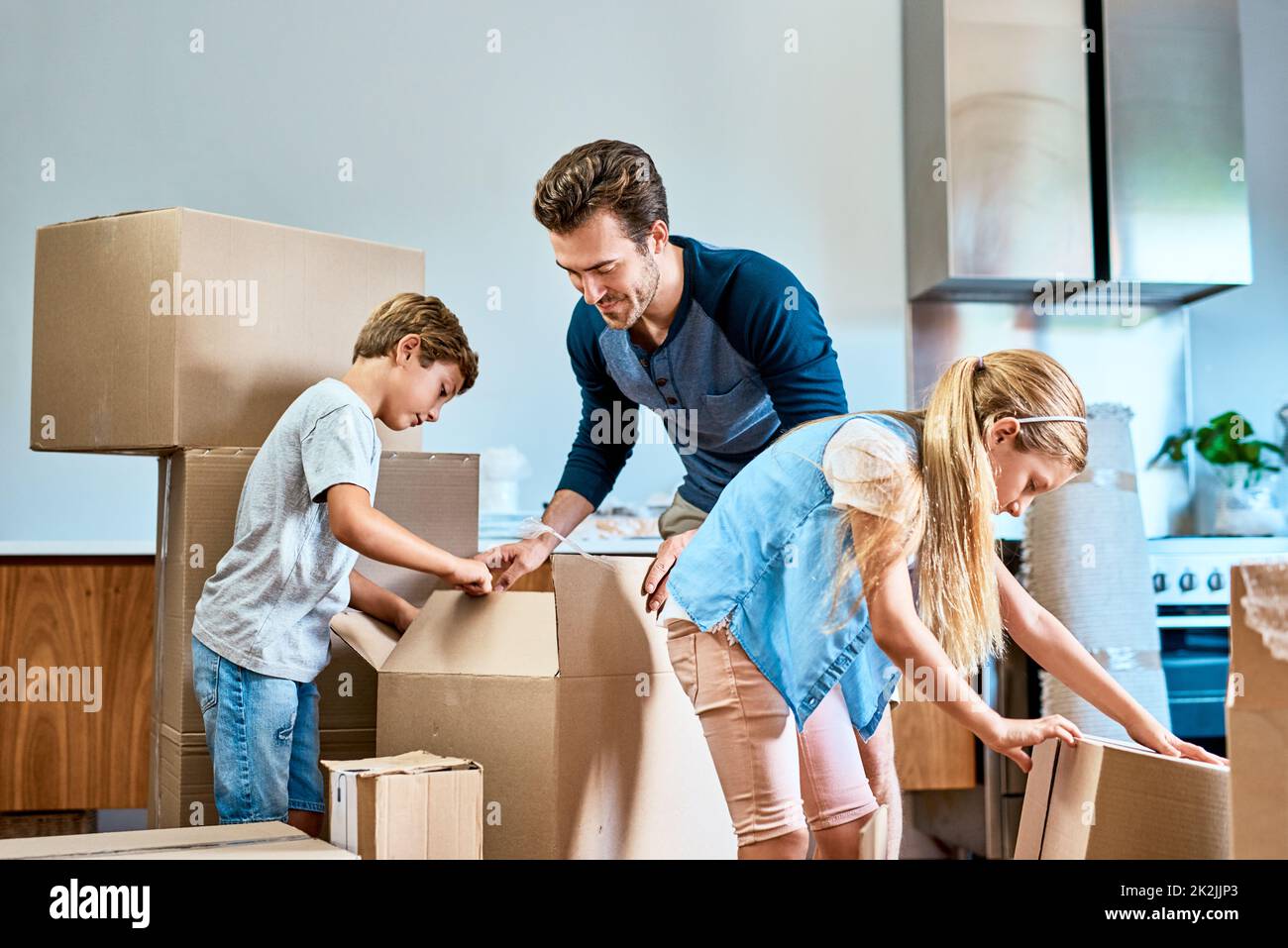 More hands make less work. Shot of a focused young family working ...
