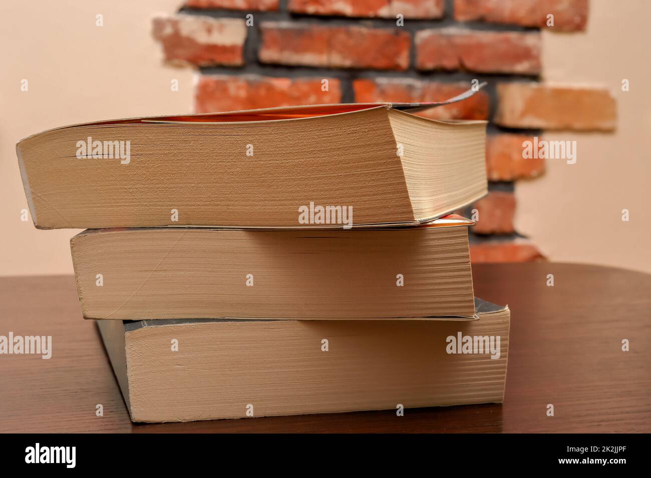 Three books lying on top of each other on the table Stock Photo - Alamy