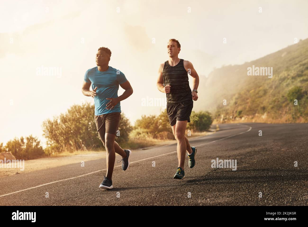 Push your mind, then your body. Shot of two sporty young men out for a ...