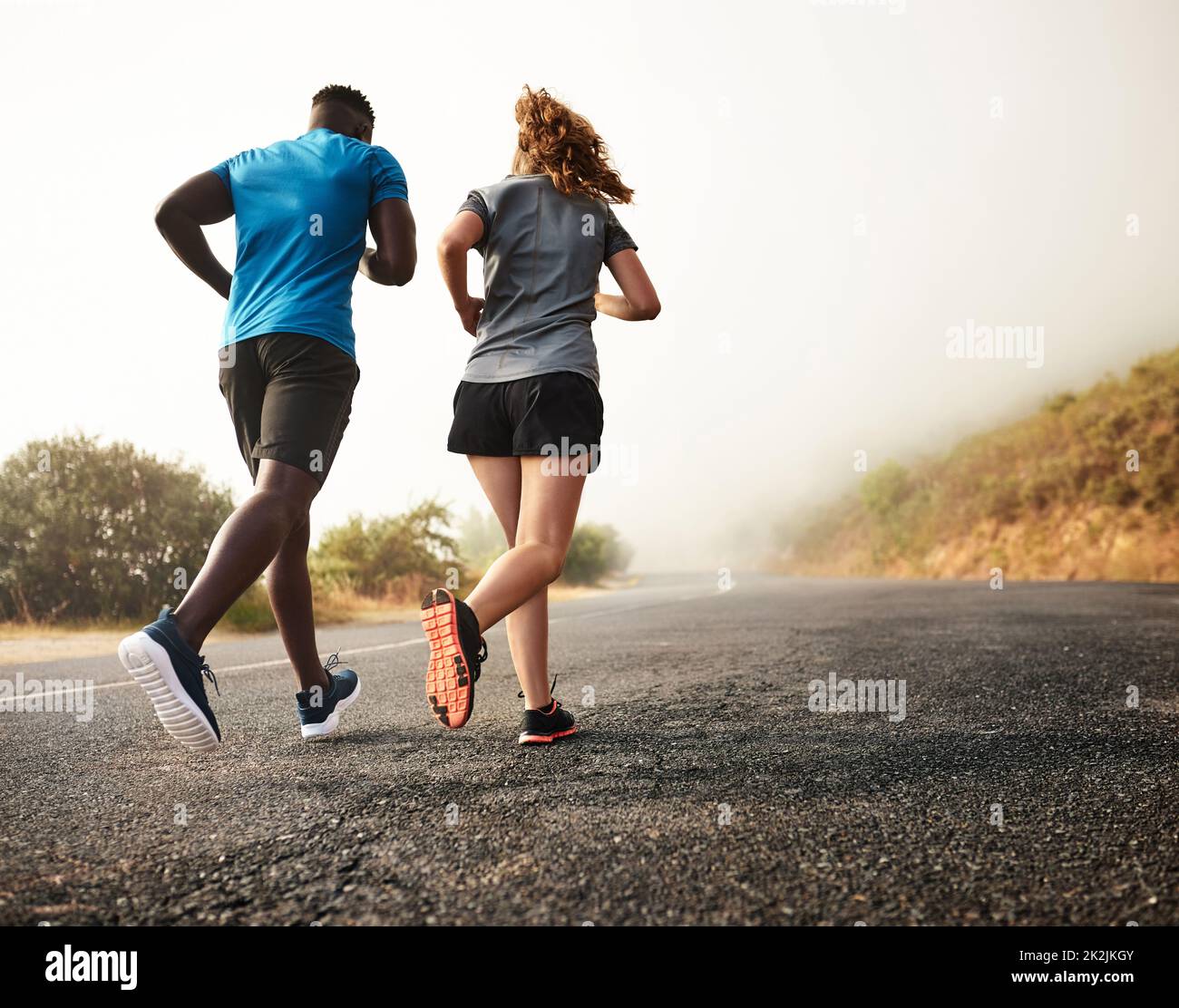 Keep up with their fitness goals. Rear view shot of two sporty young ...