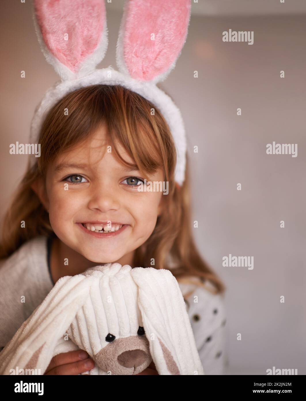 Cuddly companion. Portrait of an adorable little girl wearing bunny ...