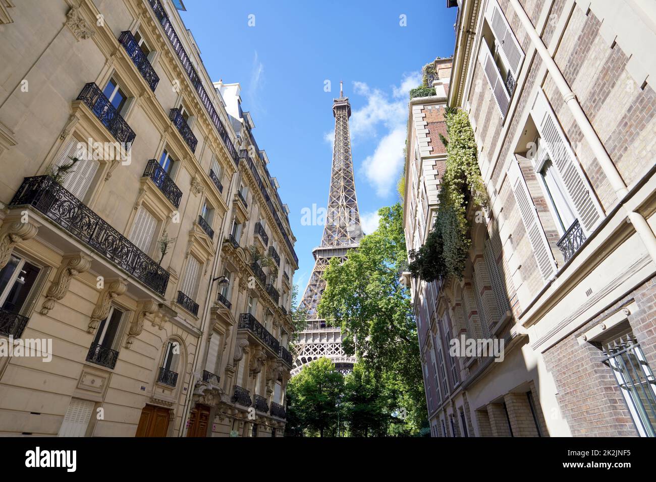 The Eiffel Tower view between palaces in Rue de l'Université street ...