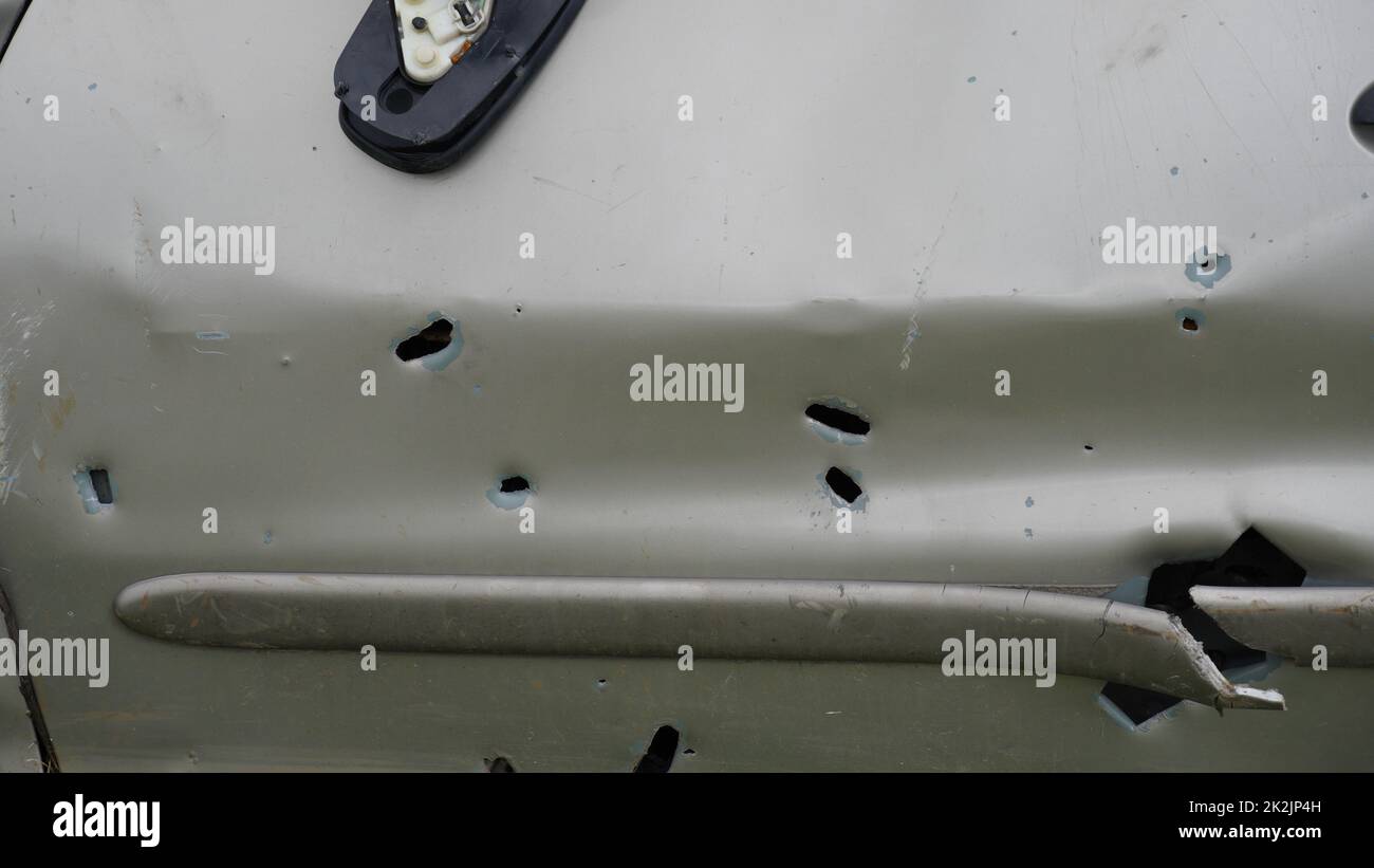 Automobile shot up shrapnel bullet shot cracked hole on car surface ...