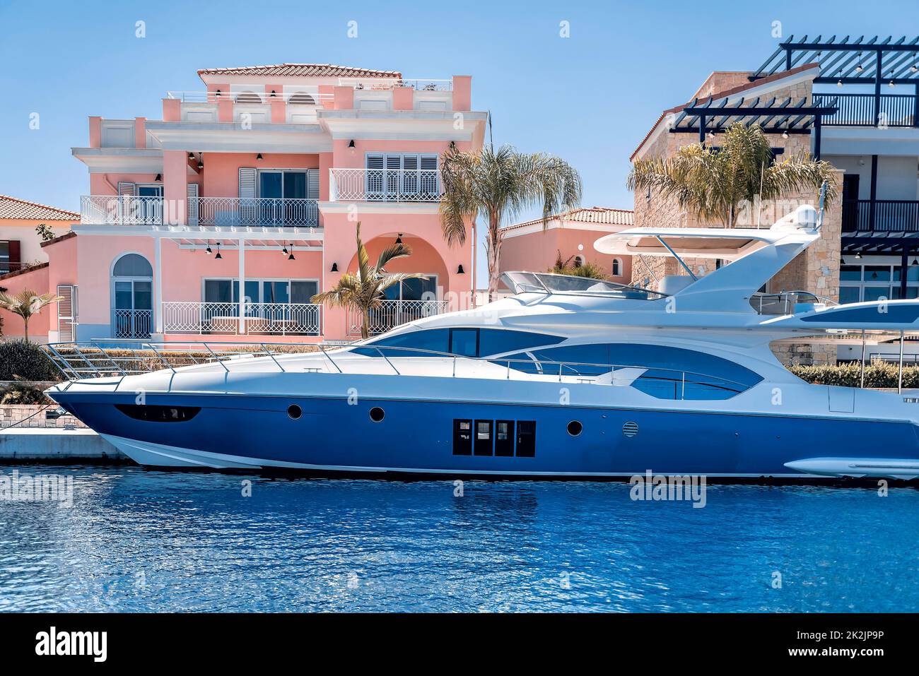 Luxury sea yacht parked near pink house in marina Stock Photo - Alamy