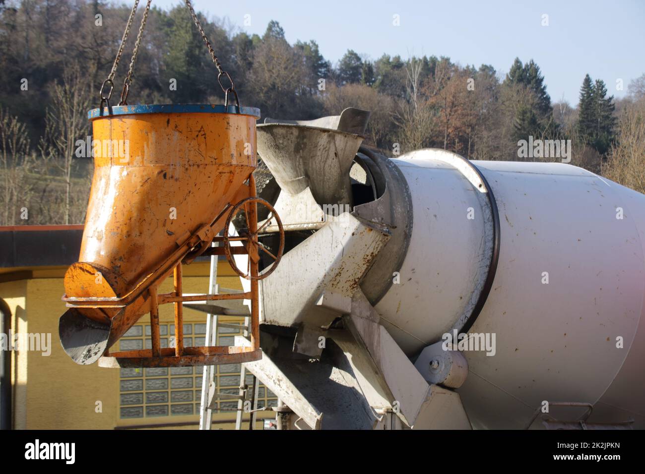 Transporting liquid concrete on a construction site through a concrete ...