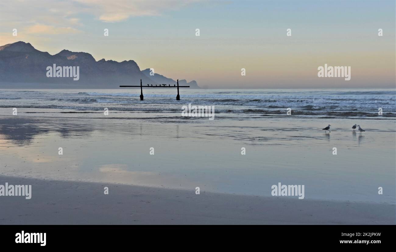 Landscape with a beautiful sunrise over the beach in Strand and the ...