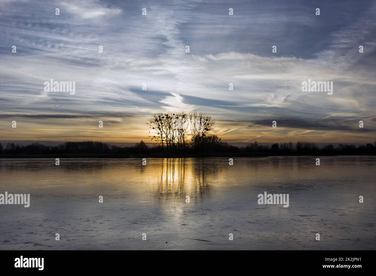 Sunset reflection in a frozen lake, January evening Stock Photo - Alamy